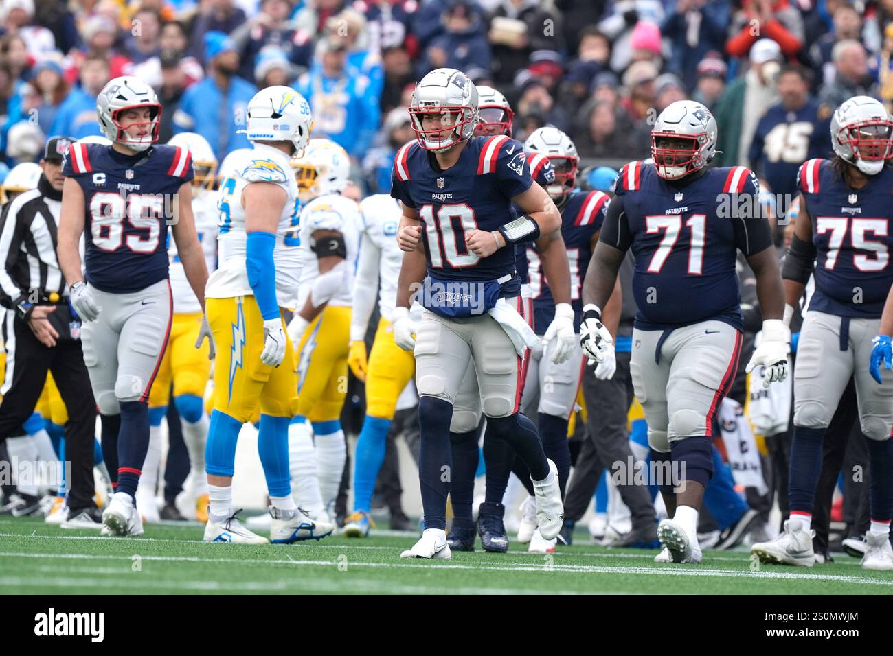 New England Patriots quarterback Drake Maye (10) runs onto the field ...