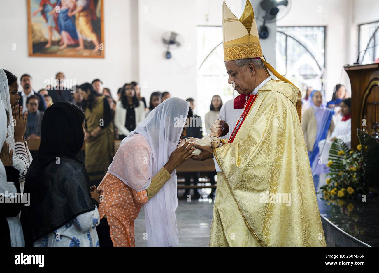 Archbishop John Moolachira holds an idol of baby Jesus Christ as ...