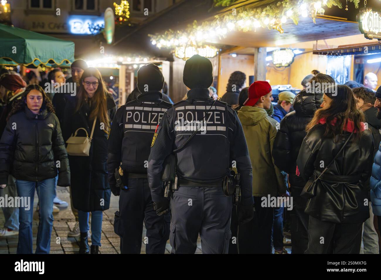 Police officers control a crowd at a Christmas market, Christmas market ...