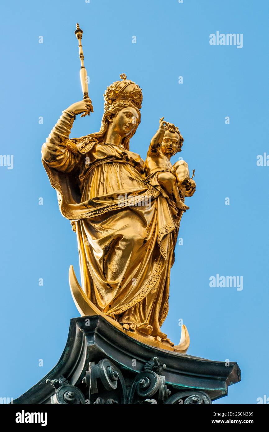 The golden Virgin Mary column in the Mariensaule main square, Munich ...