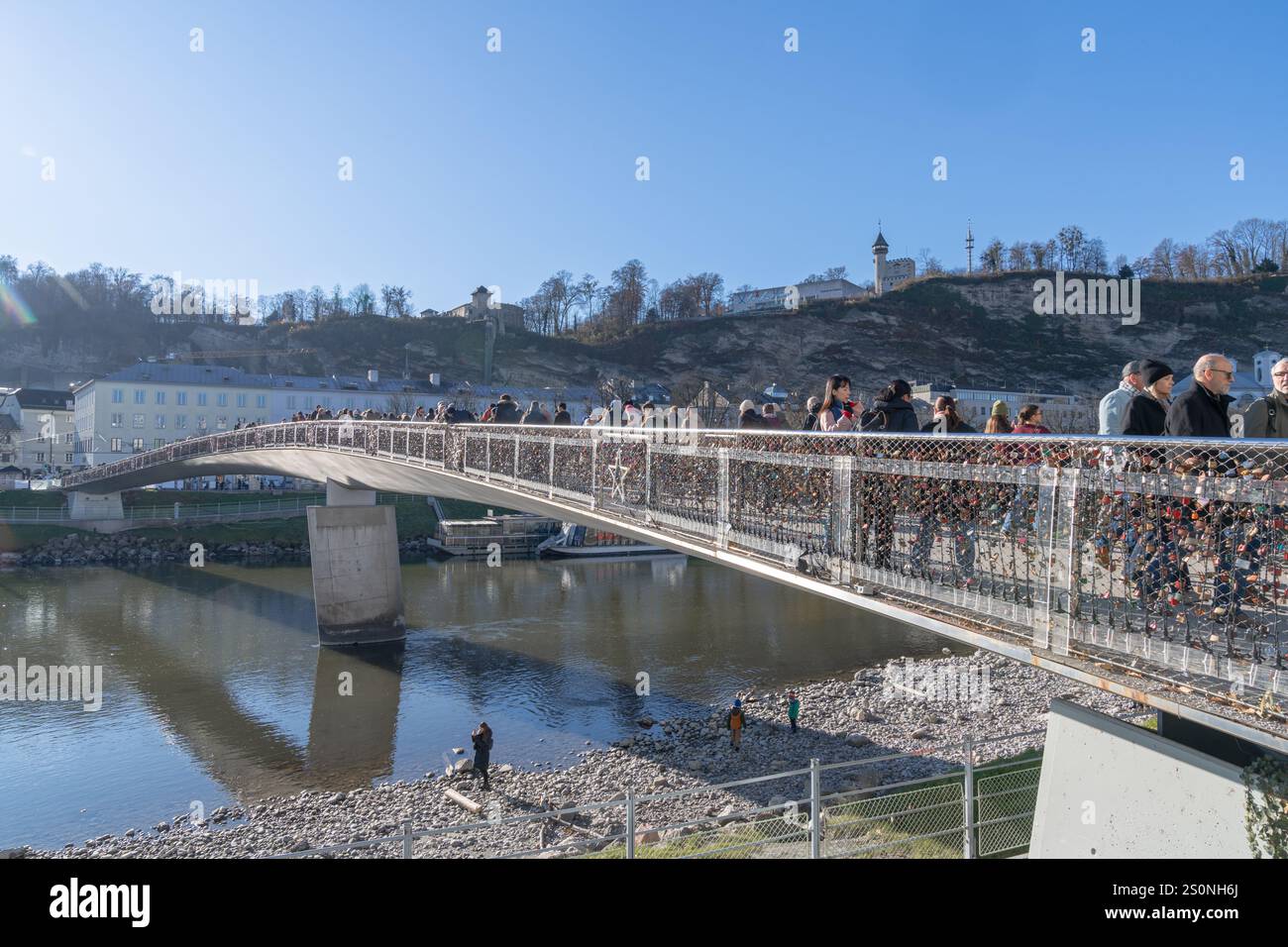 Salzburg, Austria - November 30, 2024: Tourists cross the lovelock ...