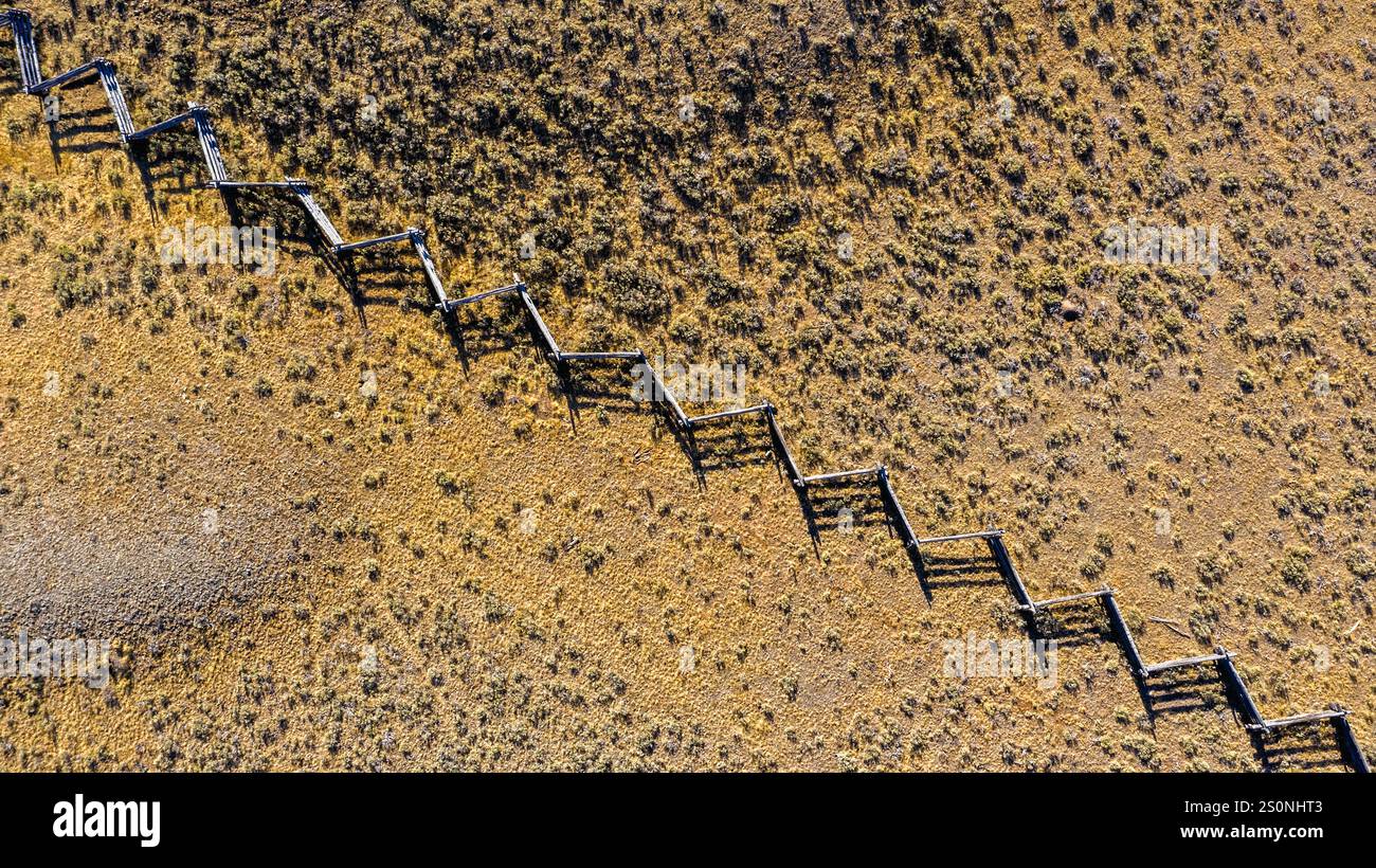 Aerial View of a Zigzag Fence in a Desert Landscape with Arid ...