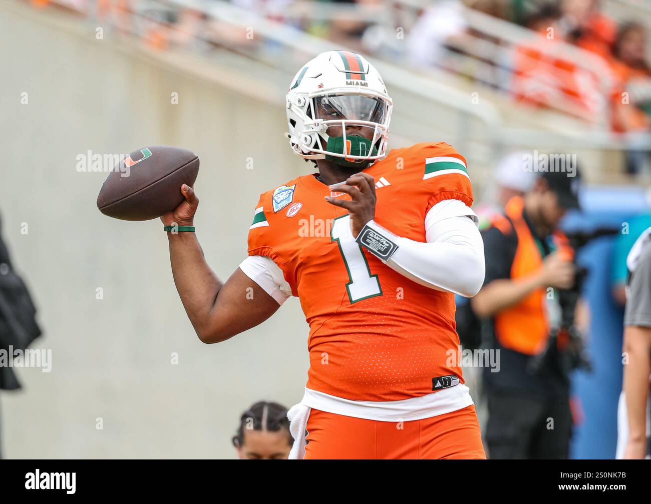 Orlando, FL, USA. 28th Dec, 2024. Miami's Cam Ward (1) warms up prior ...