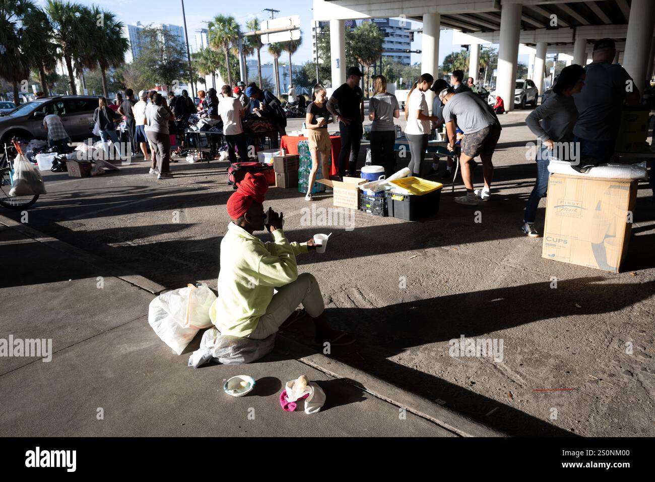 Tampa, Florida, USA. 28th Dec, 2024. A homeless woman sips coffee as ...