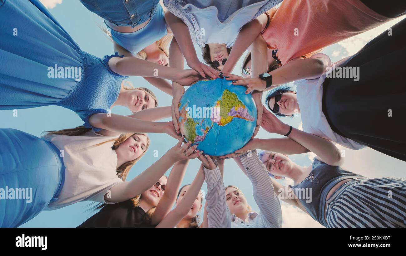Earth conservation concept. 10 girls and boys surround the rotating ...