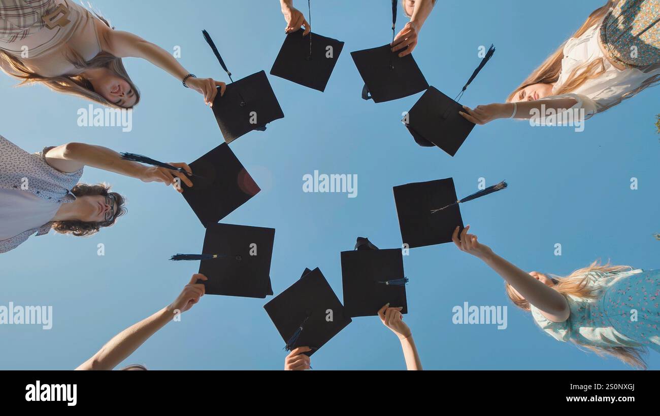 Students join their graduation caps in the shape of a circle Stock ...