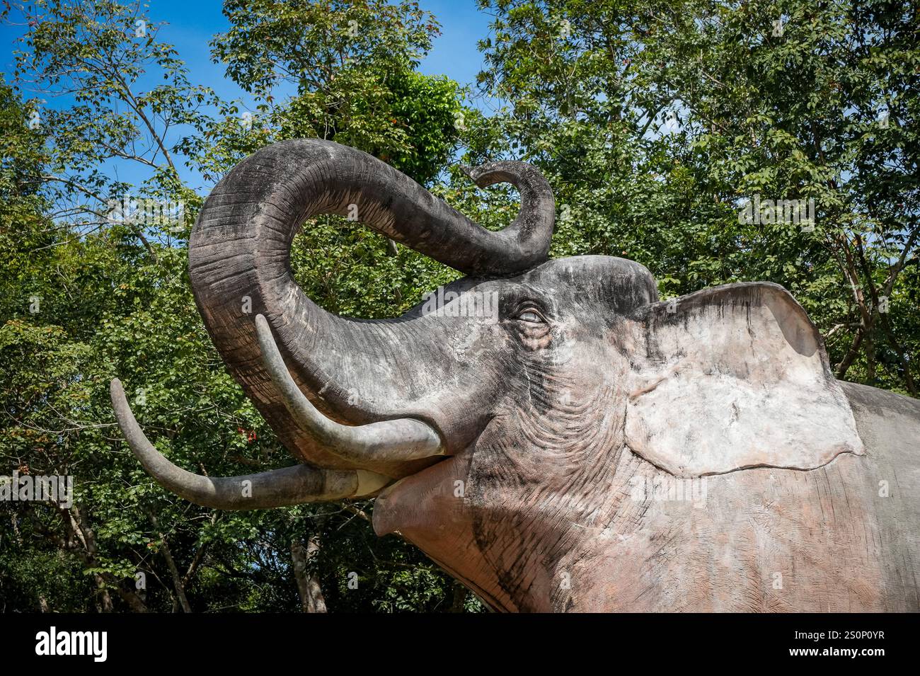 A close-up of the face of an elephant statue in the garden of the ...