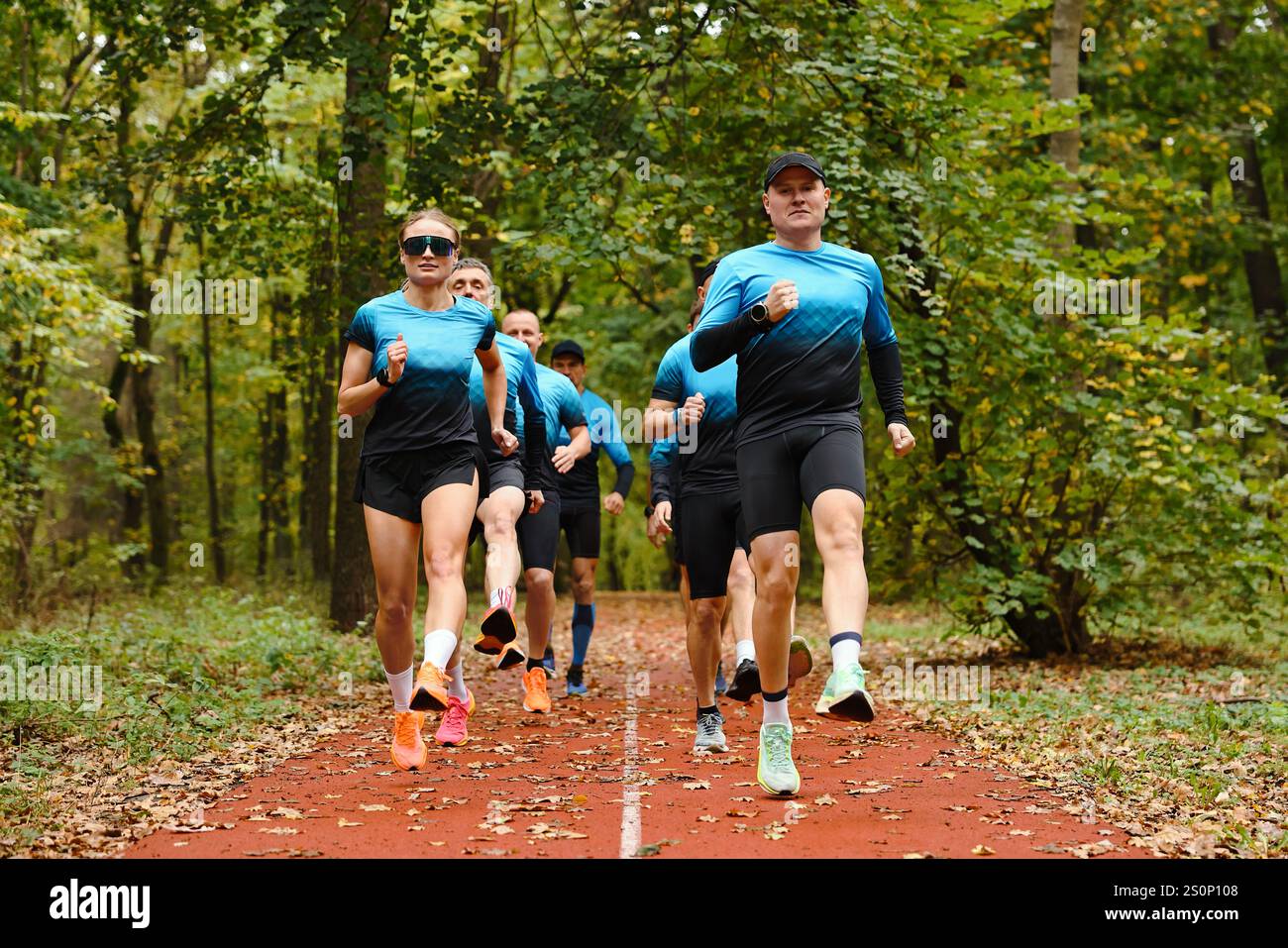Group of athletic people running in park Stock Photo - Alamy