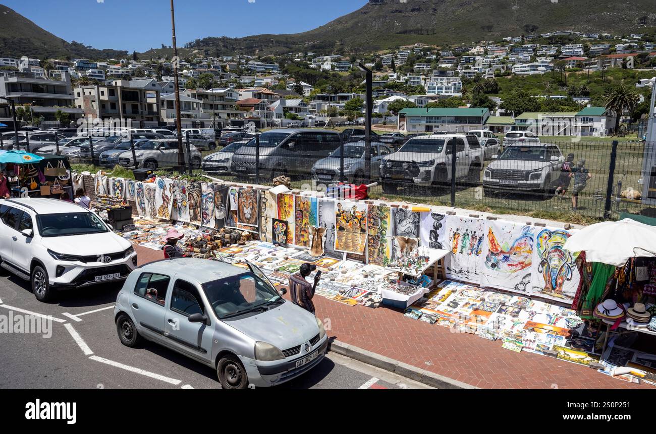 African street art and memorabilia on display for sale along the street ...