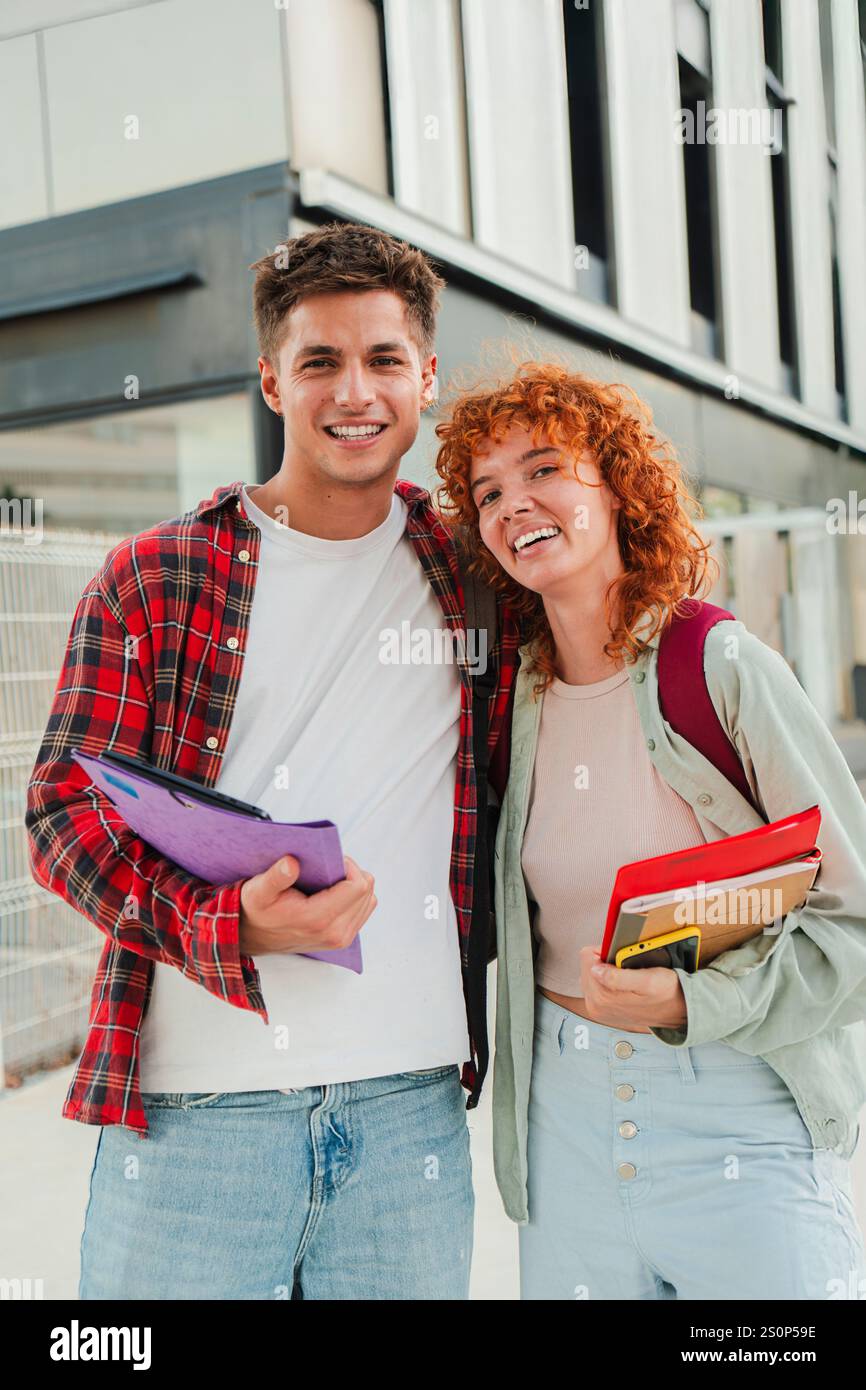 Vertical. Two cheerful classmates posing together outdoors, smiling ...
