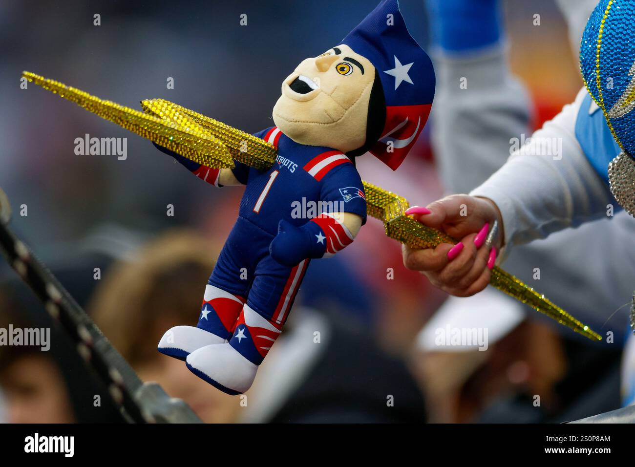A Los Angeles Chargers fans holds a New England Patriots mascot impaled ...