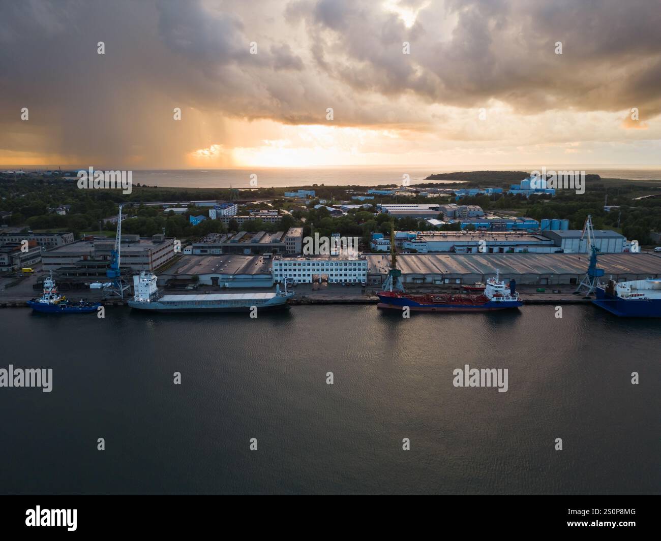 Aerial view of an industrial port with cargo ships at sunset. Dramatic ...