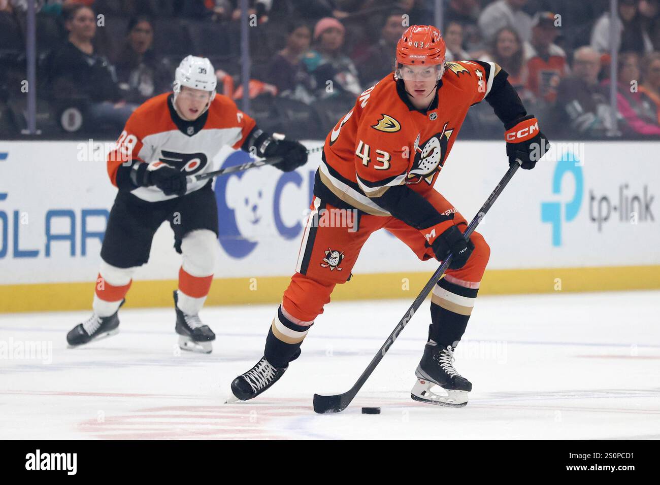 Anaheim Ducks defenseman Drew Helleson (43) controls the puck chased by ...