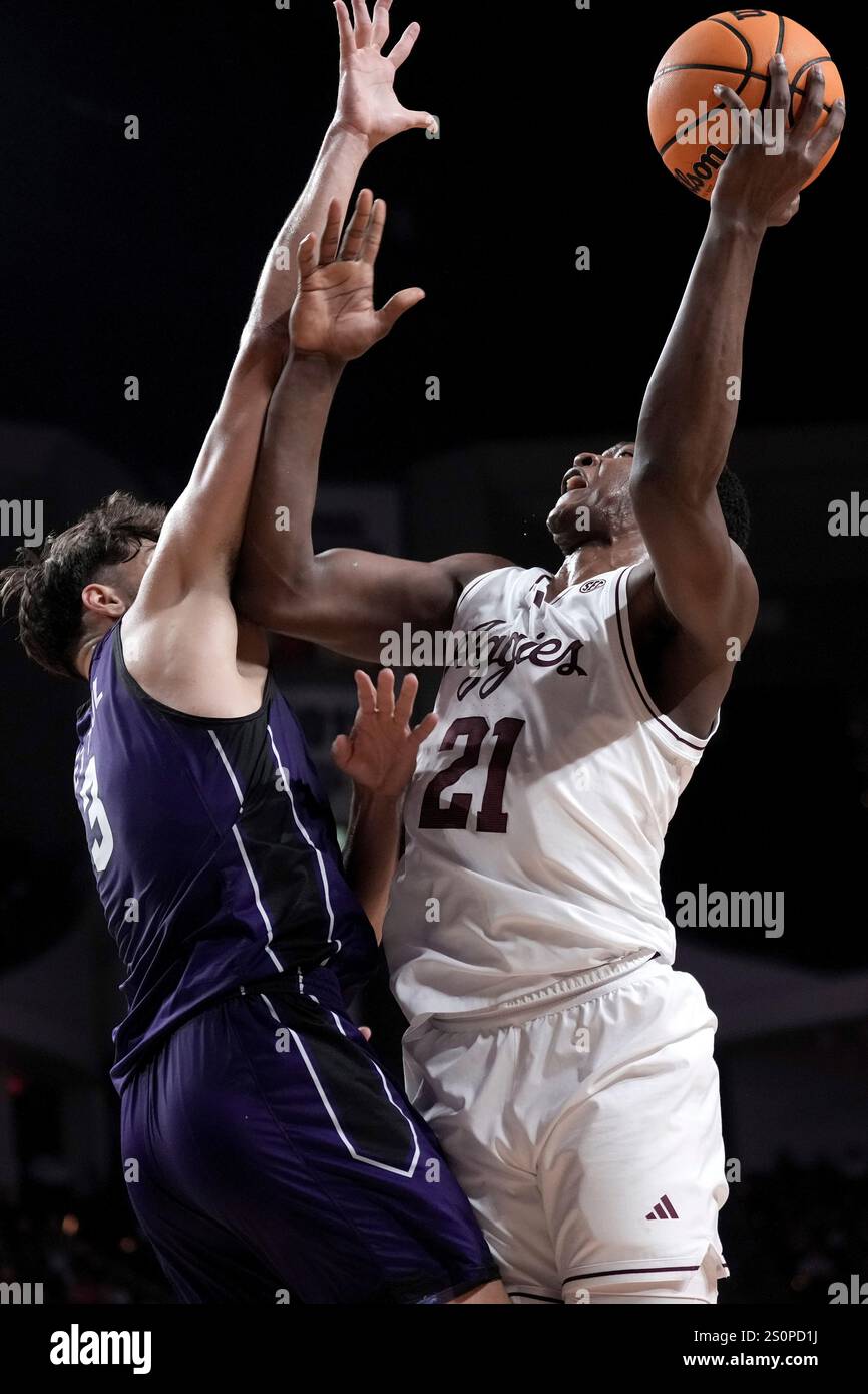 Texas A&M forward Pharrel Payne (21) goes to the basket over Abilene ...