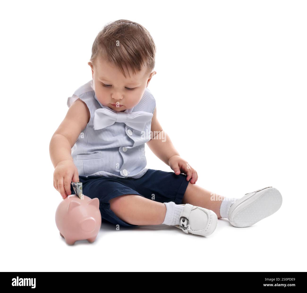 Little baby with money and piggybank on white background Stock Photo ...