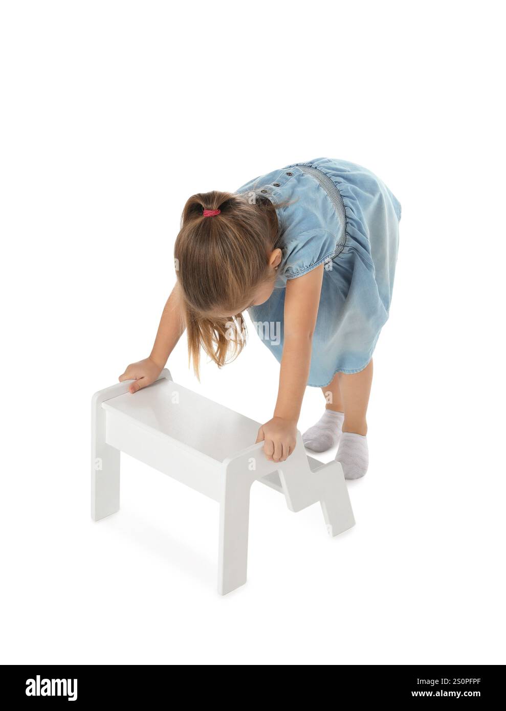 Little girl with step stool on white background Stock Photo - Alamy