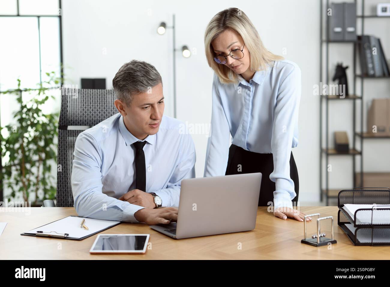 Middle aged employees working together in office Stock Photo - Alamy