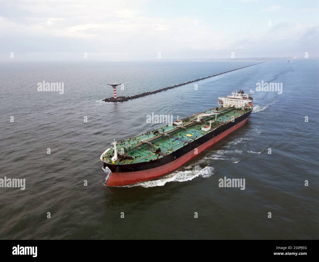 Aerial view of a large and empty oil tanker leaving the port of ...
