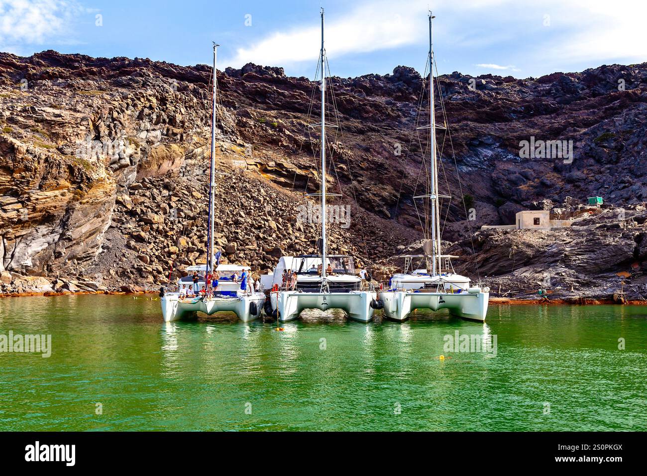 Scenic Harbor With Sailing Ships and Catamarans Surrounded by Rocky ...