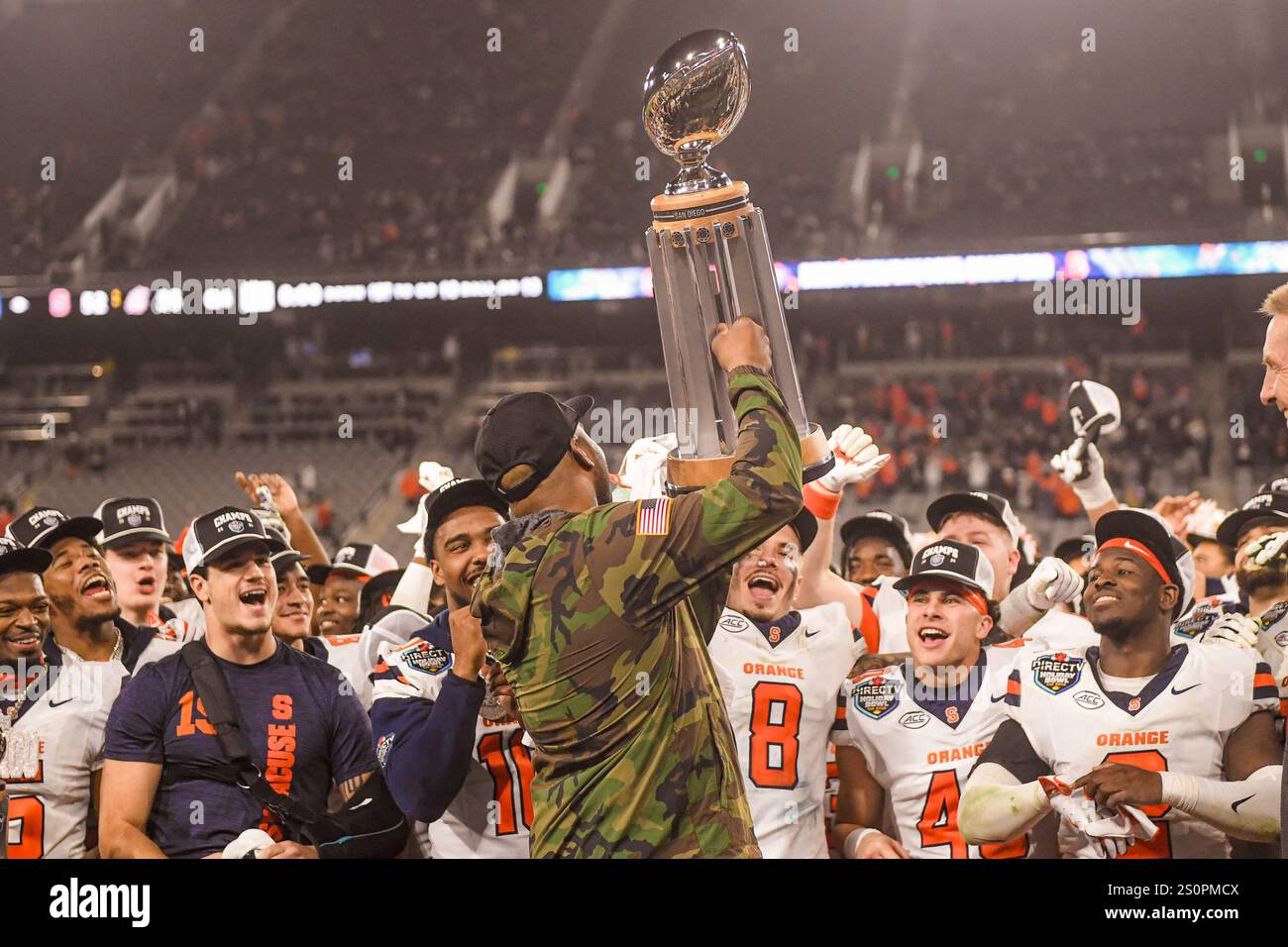 Syracuse Orange head coach Fran Brown shares the trophy with his team ...