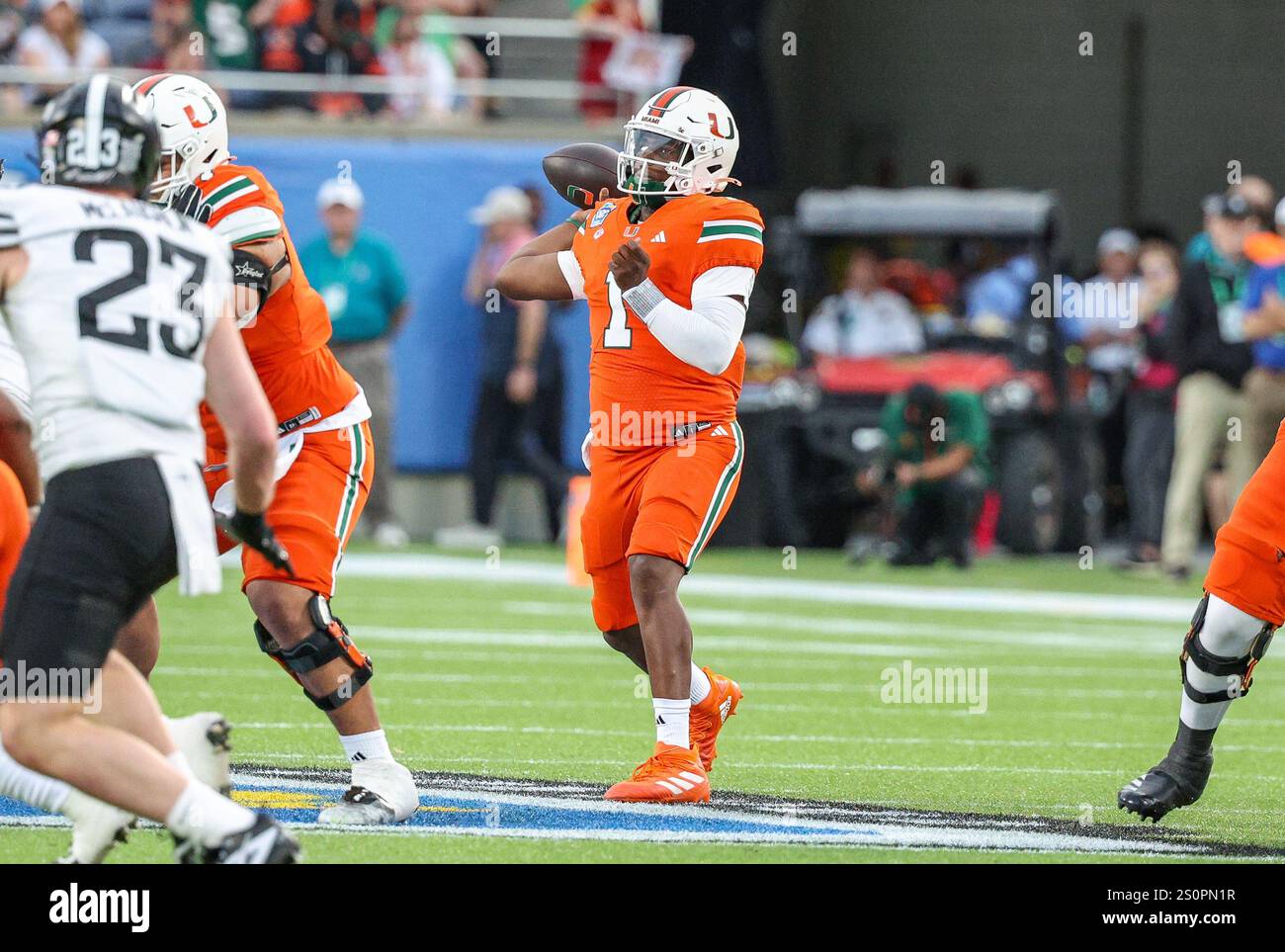 Orlando, FL, USA. 28th Dec, 2024. Miami QB Cam Ward (1) throws the ball ...