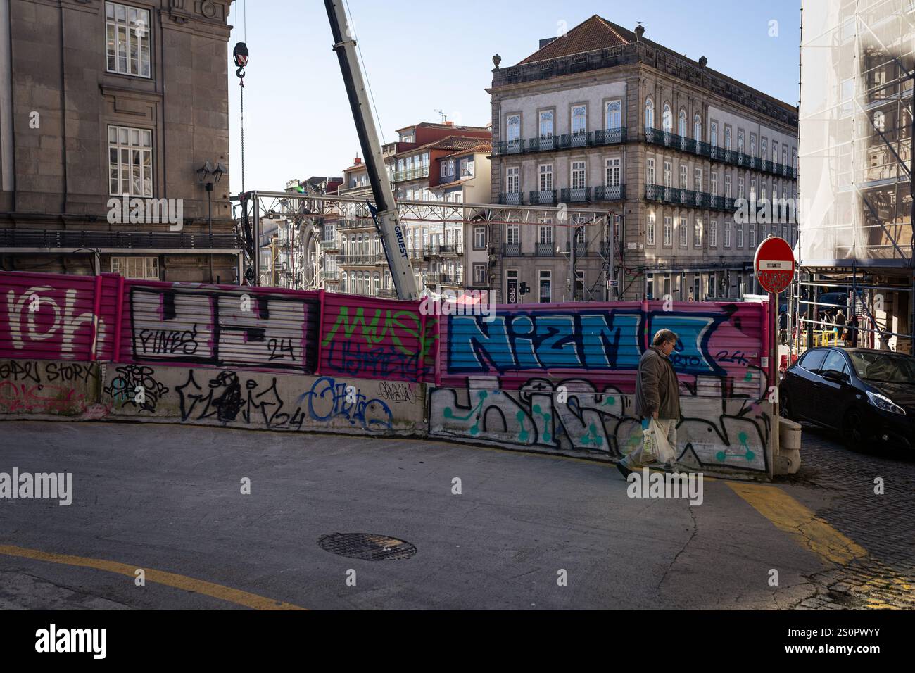 Porto, Portugal. 20th Dec, 2024. A man passes in the construction site ...