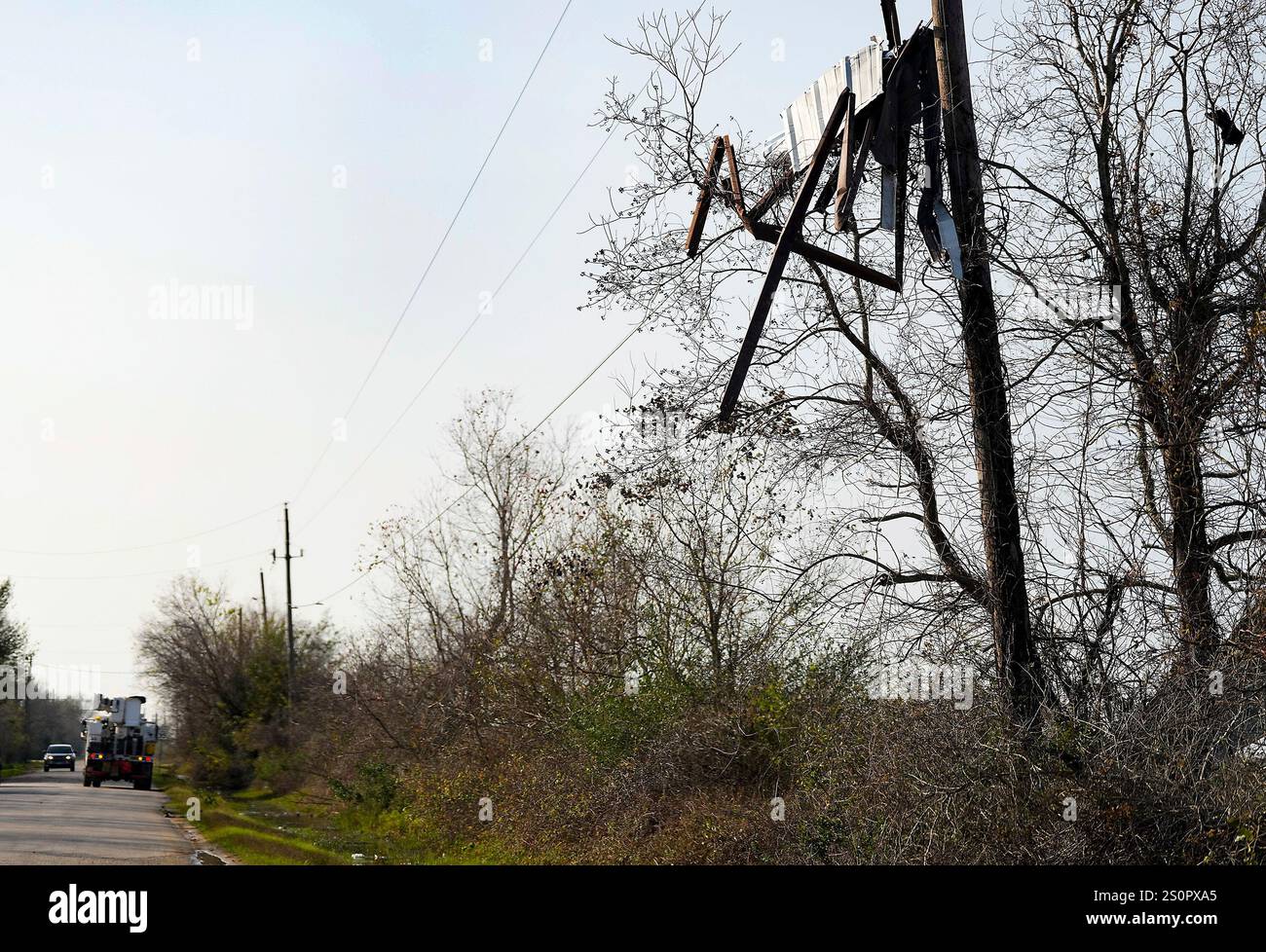 Debris clings to power lines following a tornado that went through Katy ...