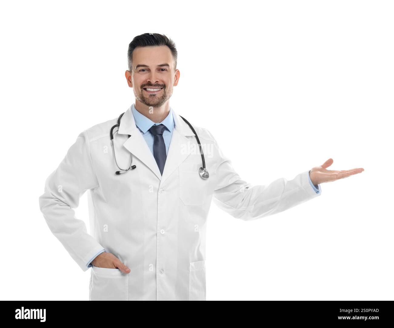 Smiling doctor with stethoscope pointing at something on white ...