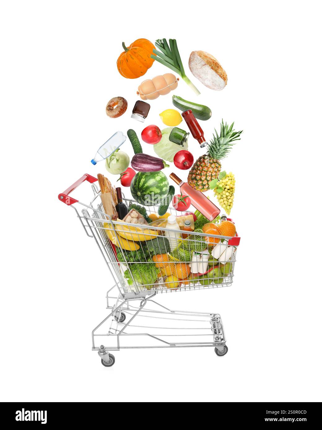 Many different products falling into shopping cart on white background ...