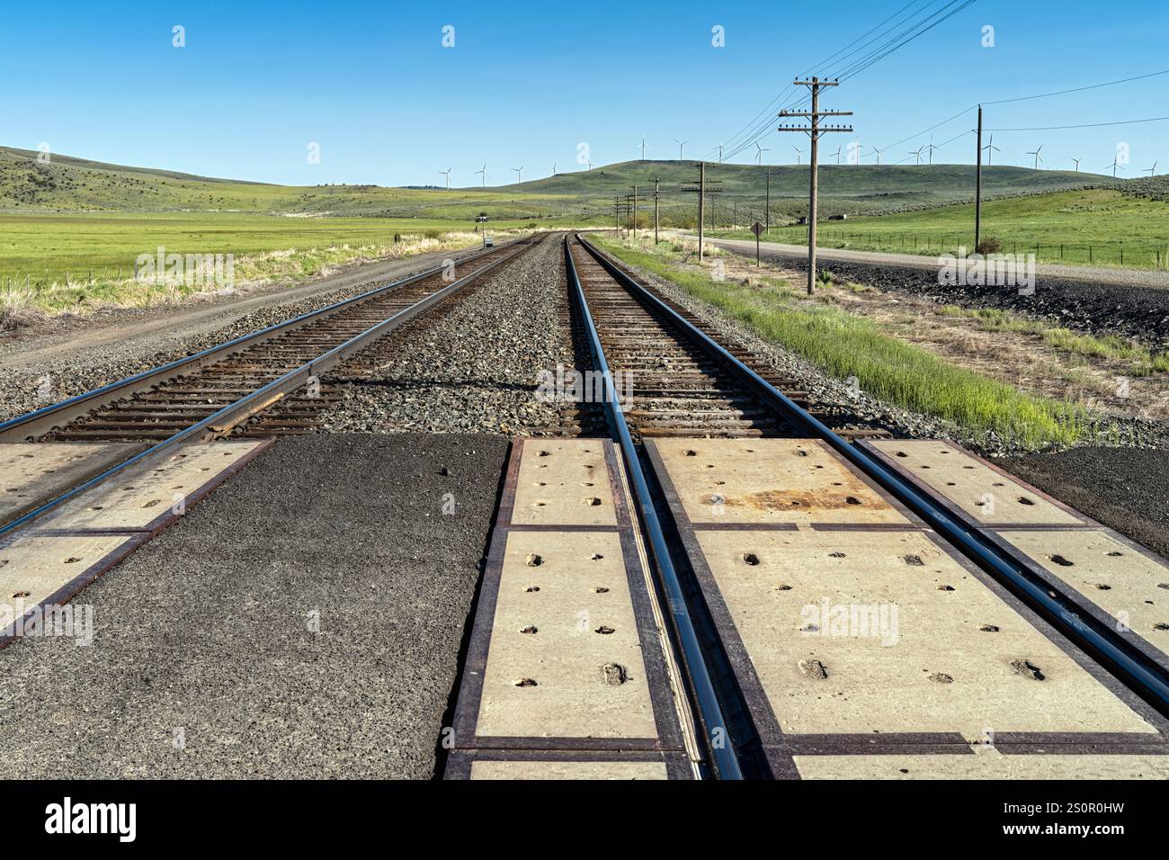 The two sets of railroad tracks at a crossing in Telocaset, Oregon, USA ...