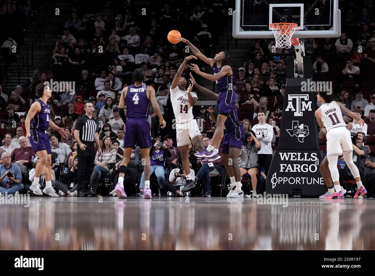 Abilene Christian guard Dontrez Williams (6) blocks a shot by Texas A&M ...