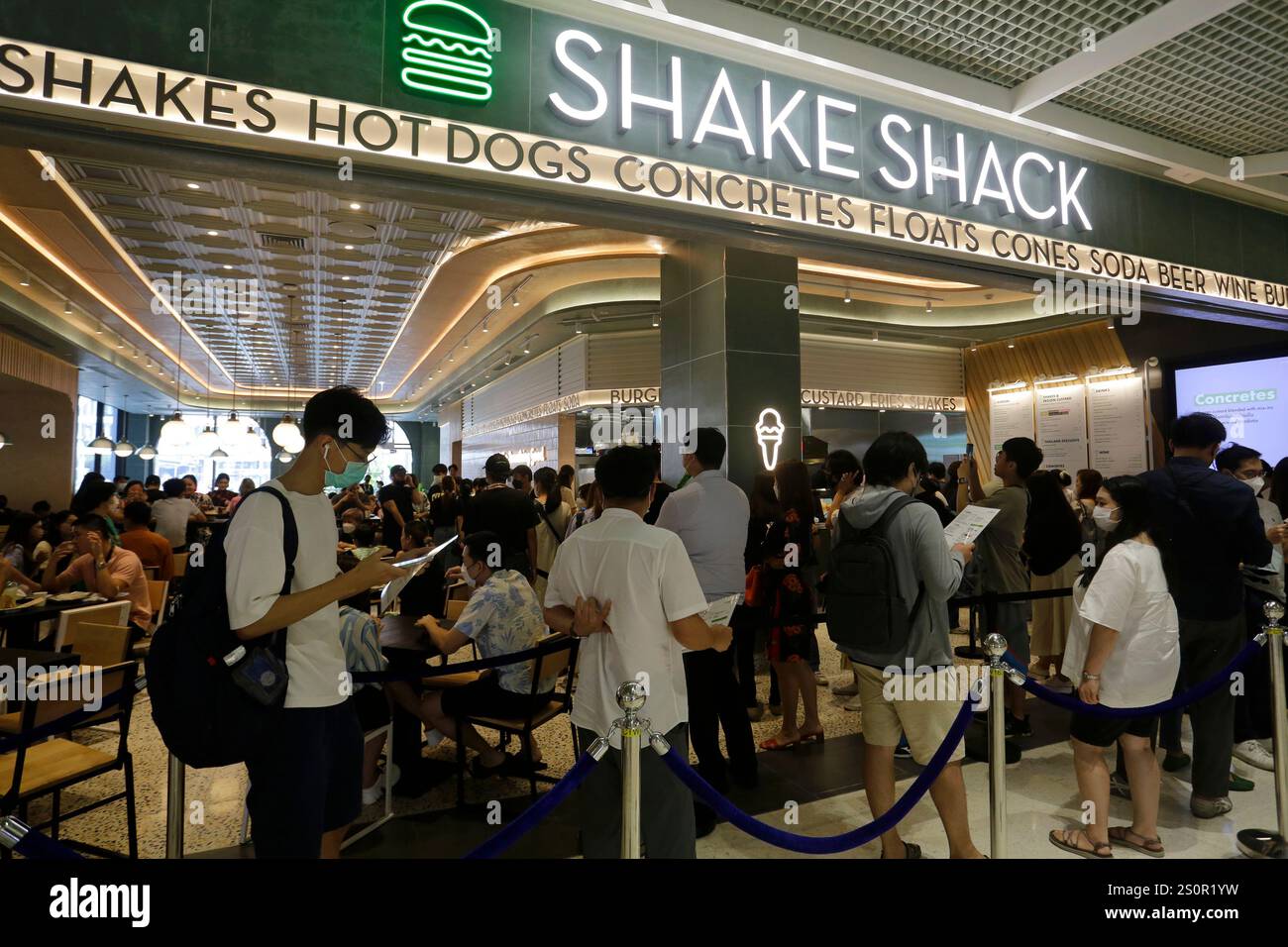 Bangkok, Thailand - April 12, 2023: People stand in line at the newly opened Shake Shack fast ...