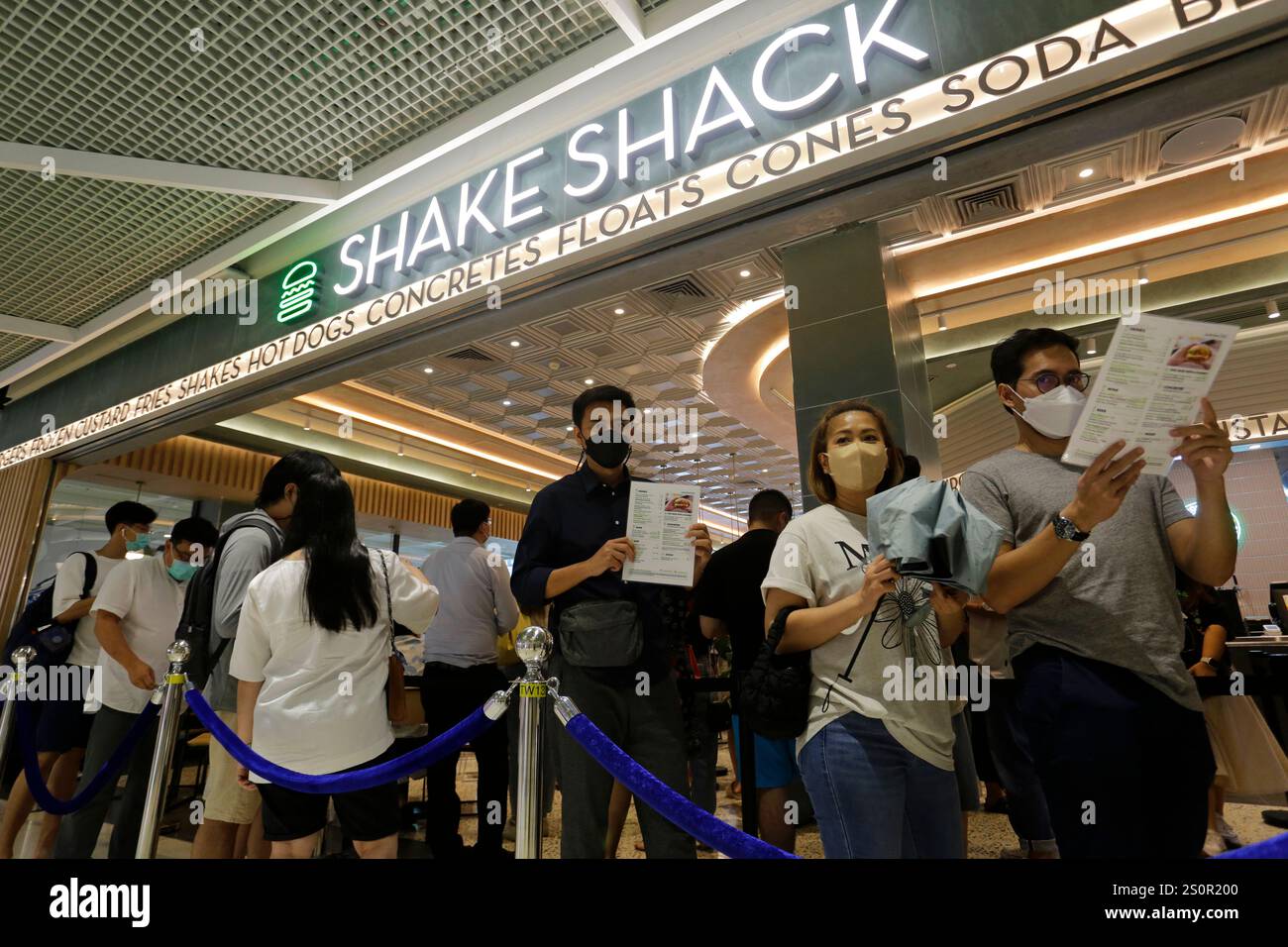Bangkok, Thailand - April 12, 2023: People stand in line at the newly opened Shake Shack fast ...