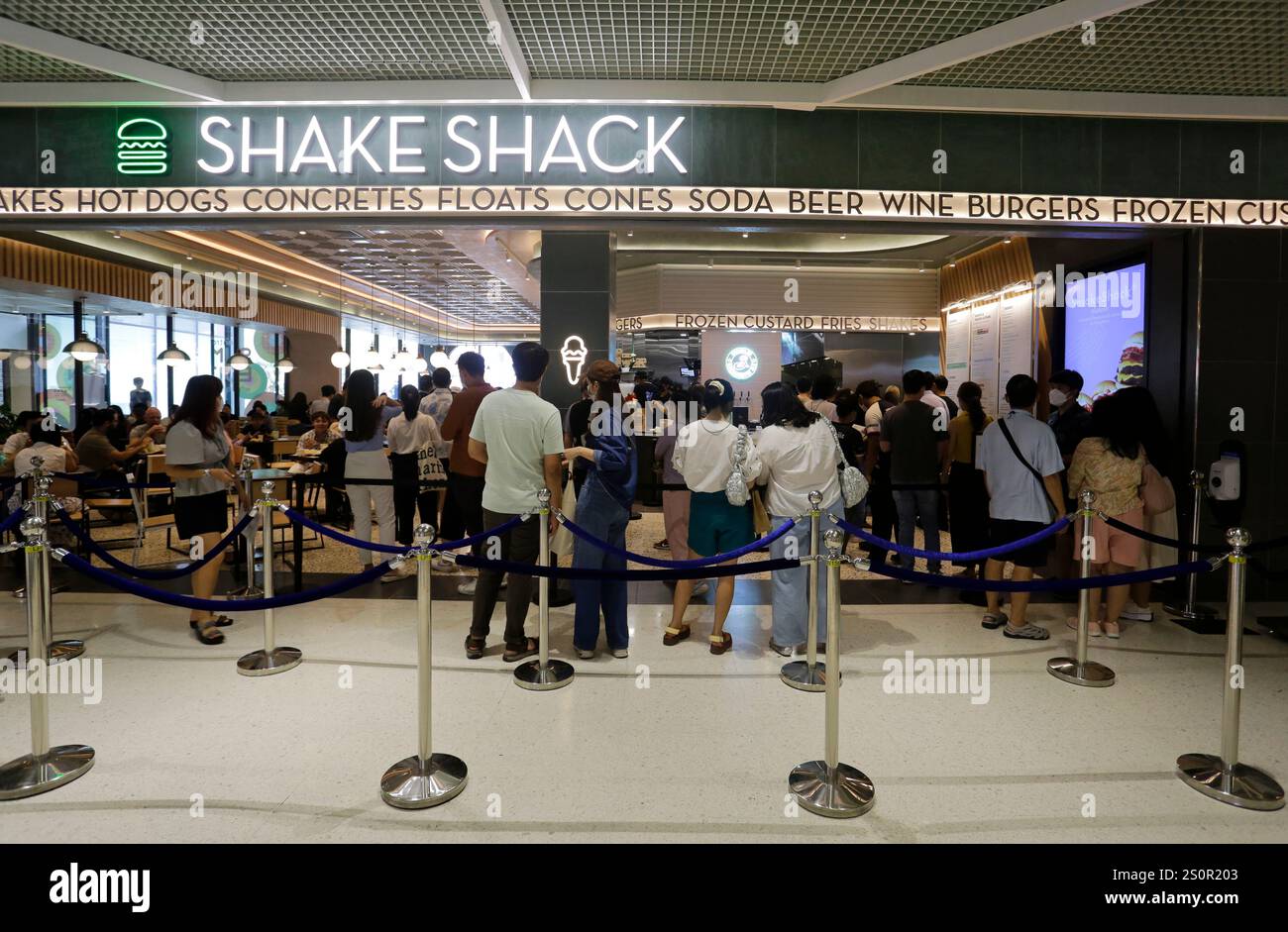 Bangkok, Thailand - April 12, 2023: People stand in line at the newly opened Shake Shack fast ...