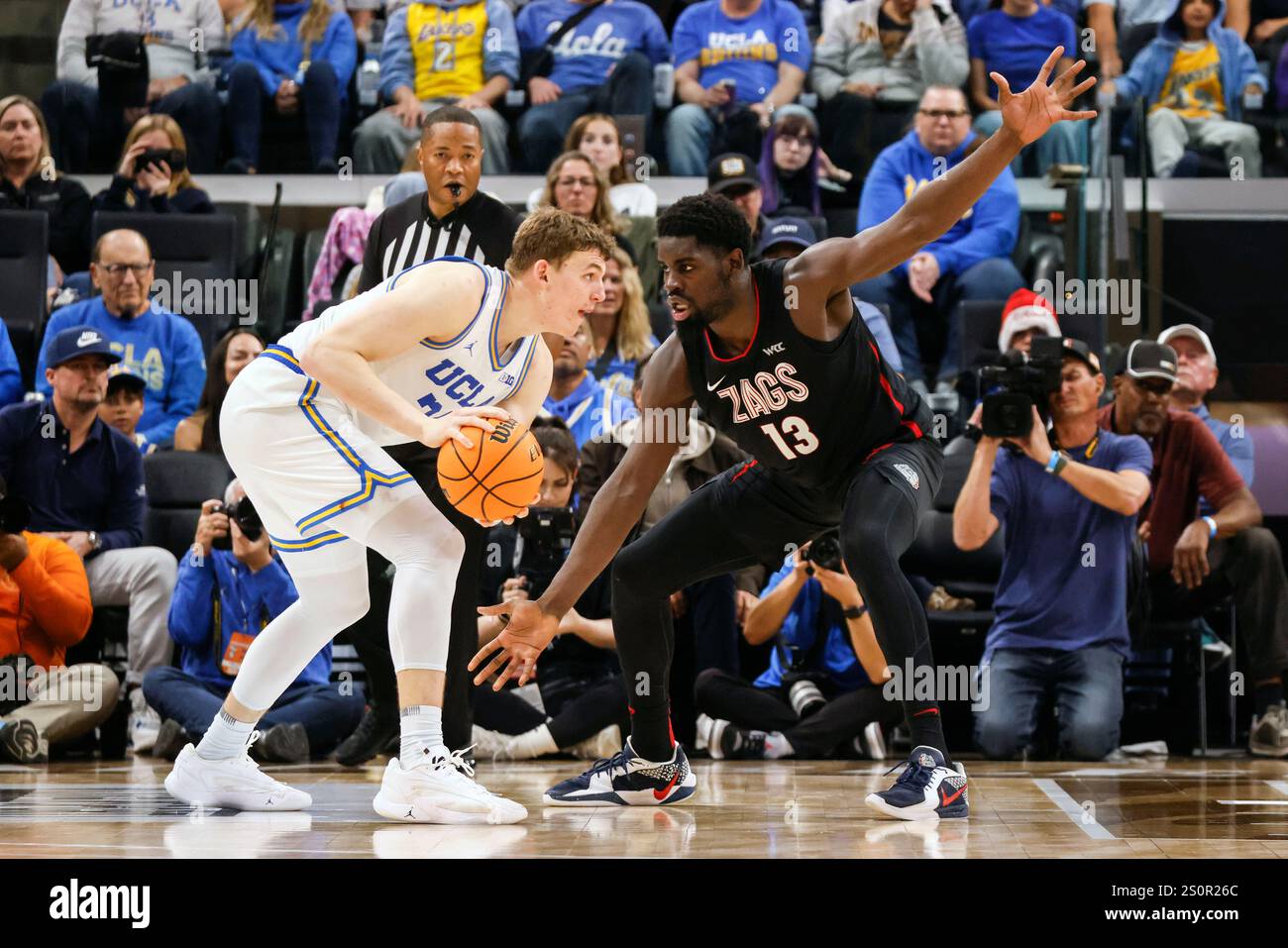 UCLA's Tyler Bilodeau, left, dribbles against Gonzaga's Graydon Lemke ...