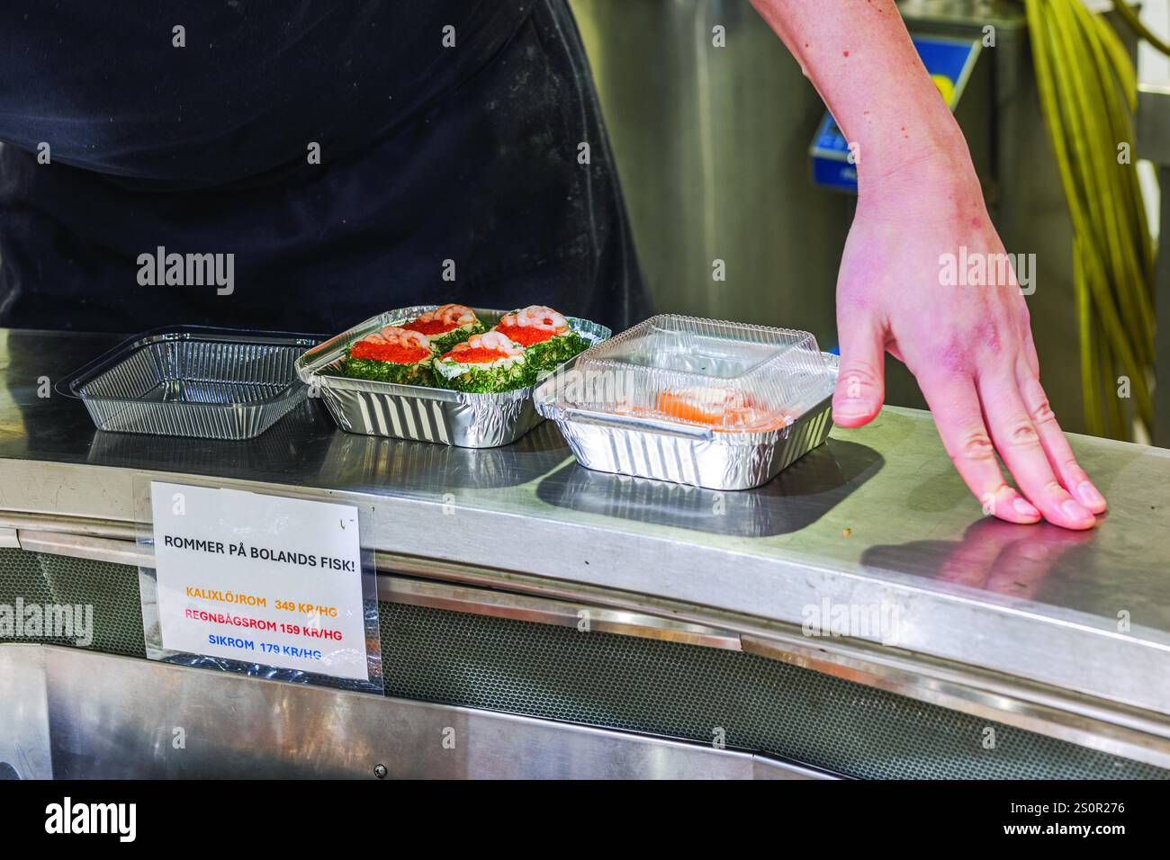 Seafood counter with prepared shrimp dishes in aluminum trays on ...