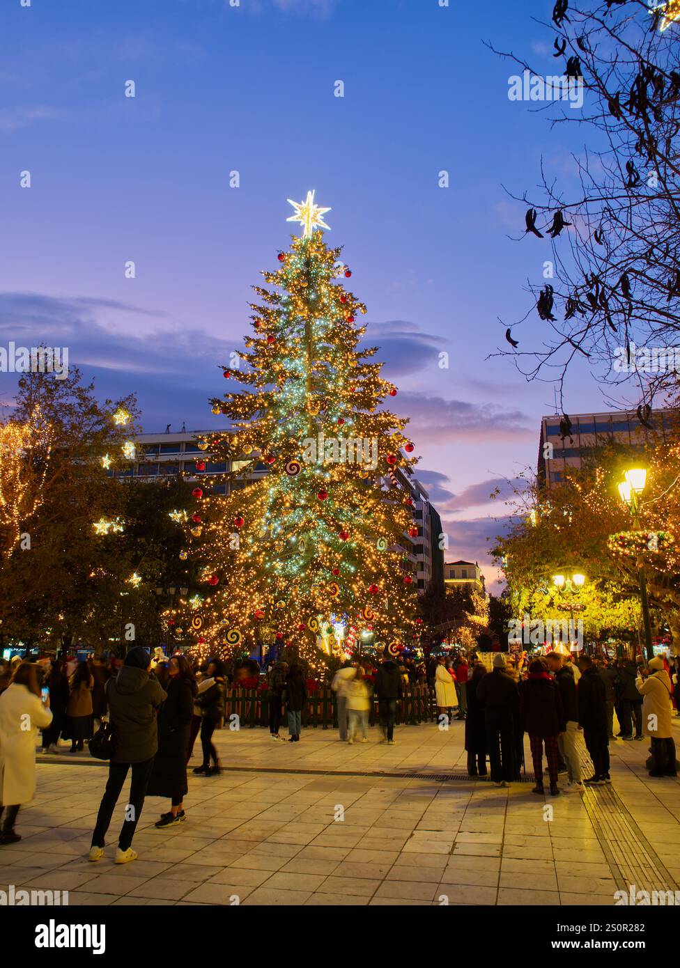 Beautifully lit Christmas tree in Syntagma square with crowd gathering ...