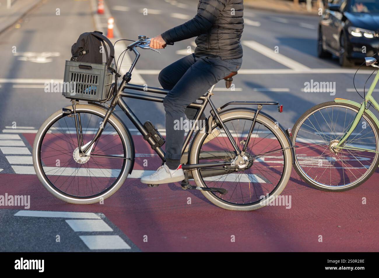 female cyclist on red bike path Stock Photo - Alamy