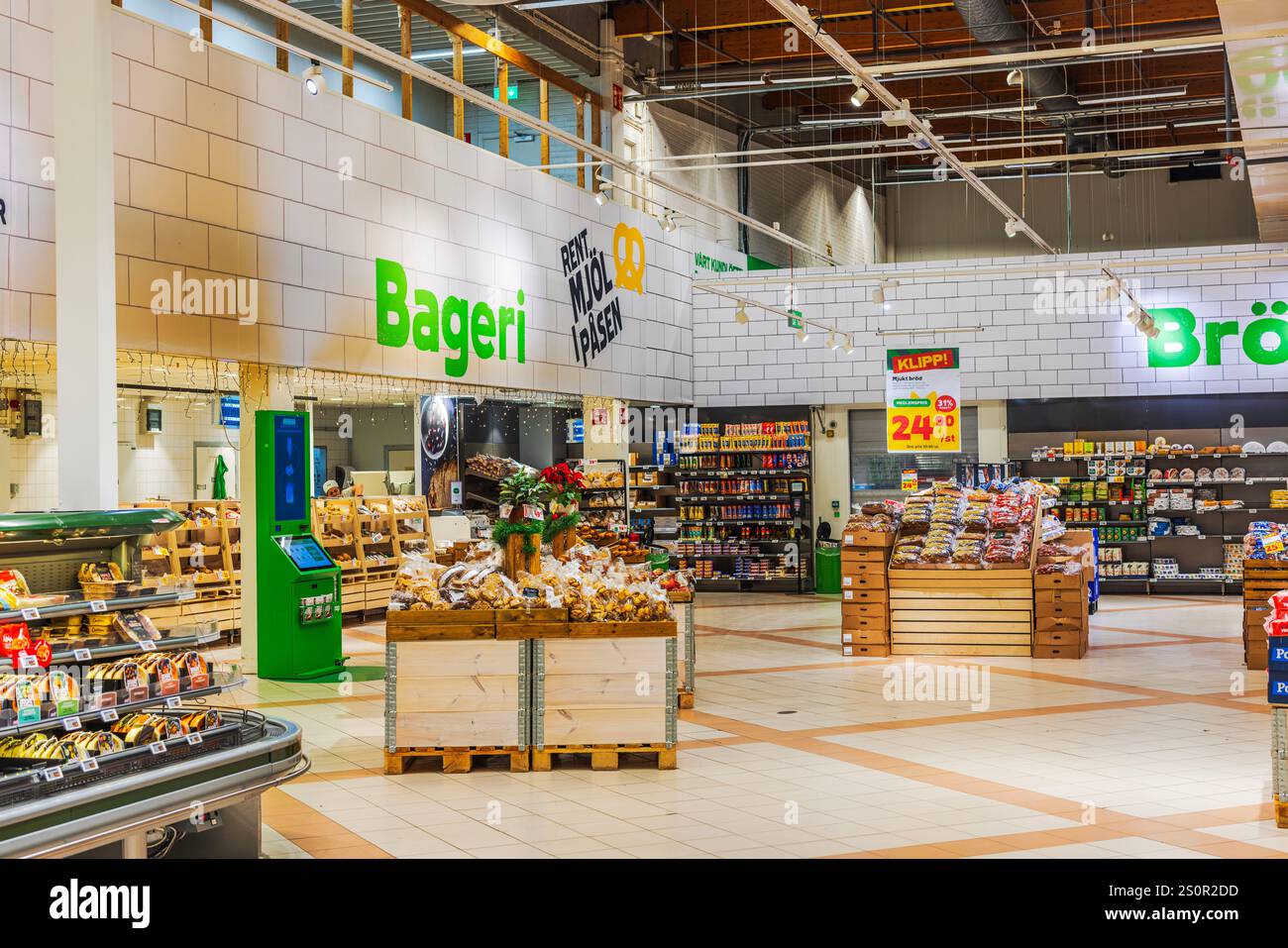 Bright bakery section in supermarket with fresh bread, pastries, and ...