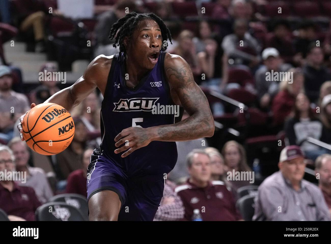 Abilene Christian guard Quion Williams (5) looks to drive the lane ...