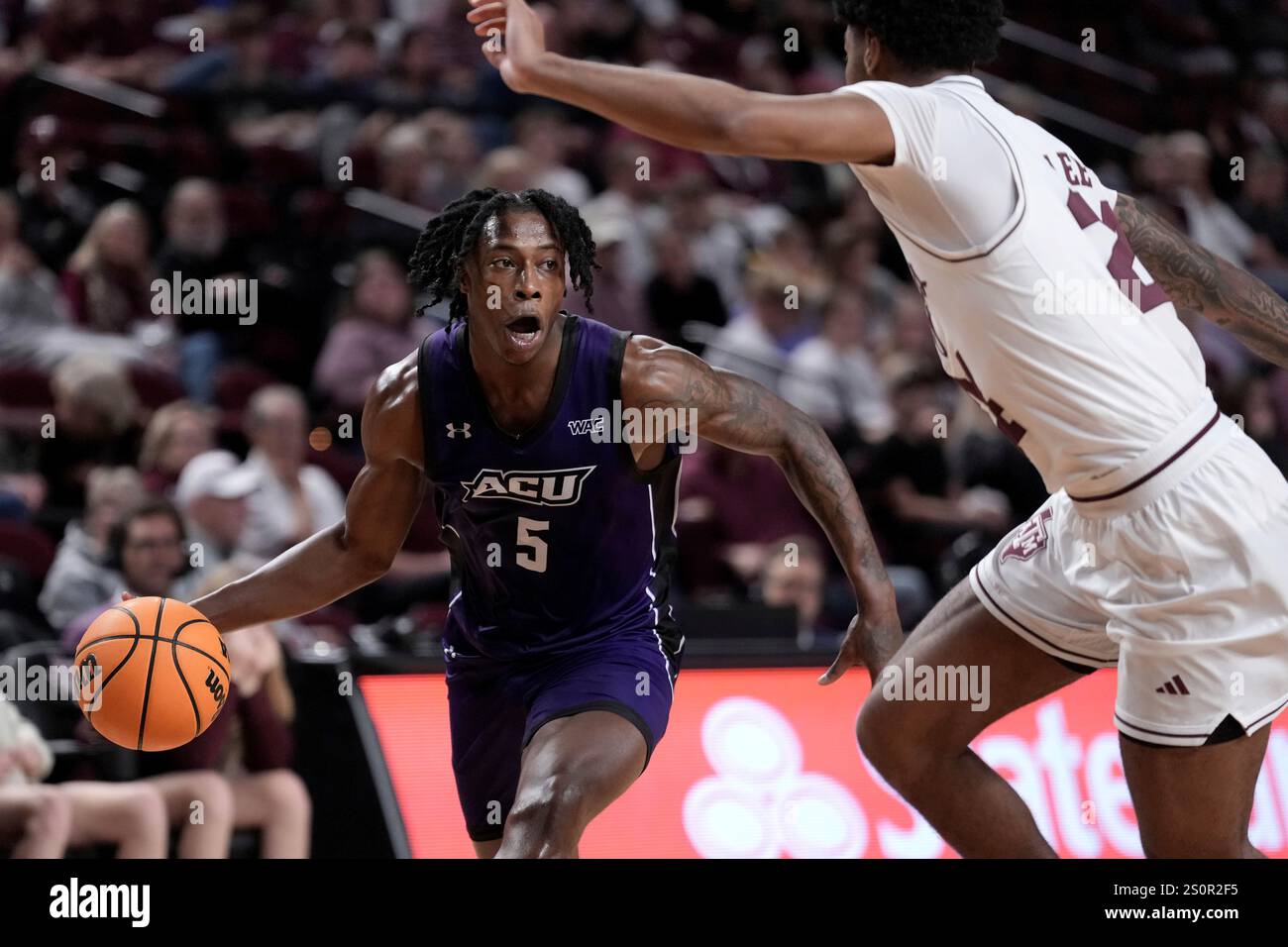 Abilene Christian guard Quion Williams (5) looks to drive the lane against Texas A&M guard ...