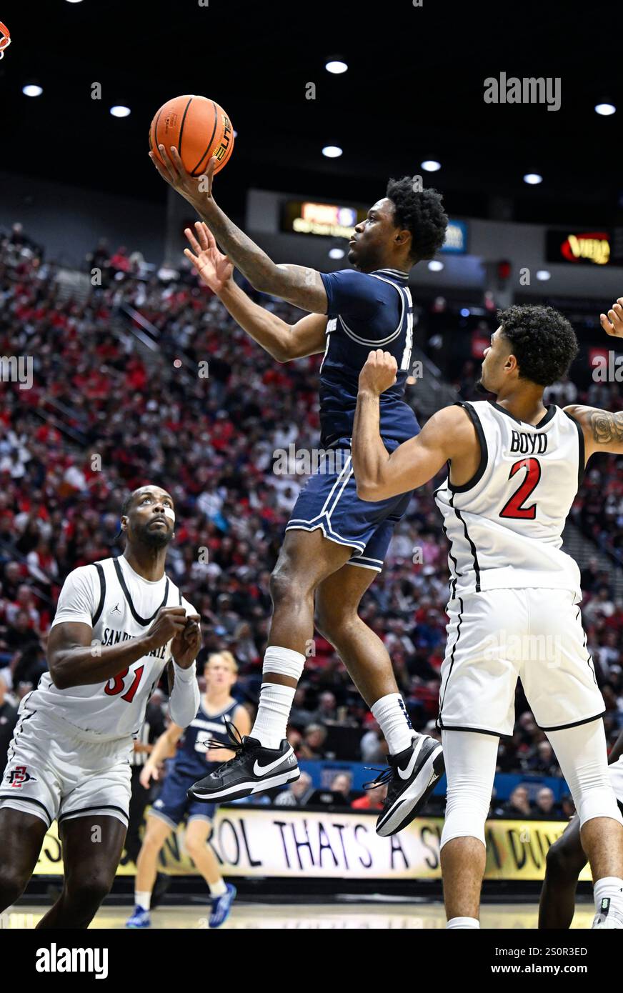Utah State guard Deyton Albury (13) shoots between San Diego State guard San Diego State forward ...