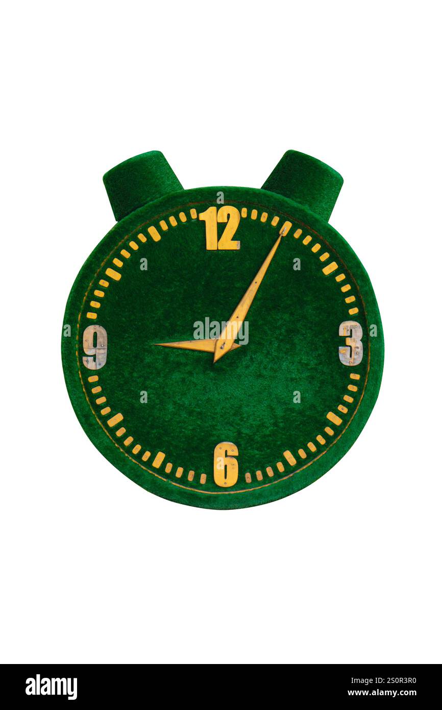 A green vintage-style alarm clock with yellow hands and numbers ...