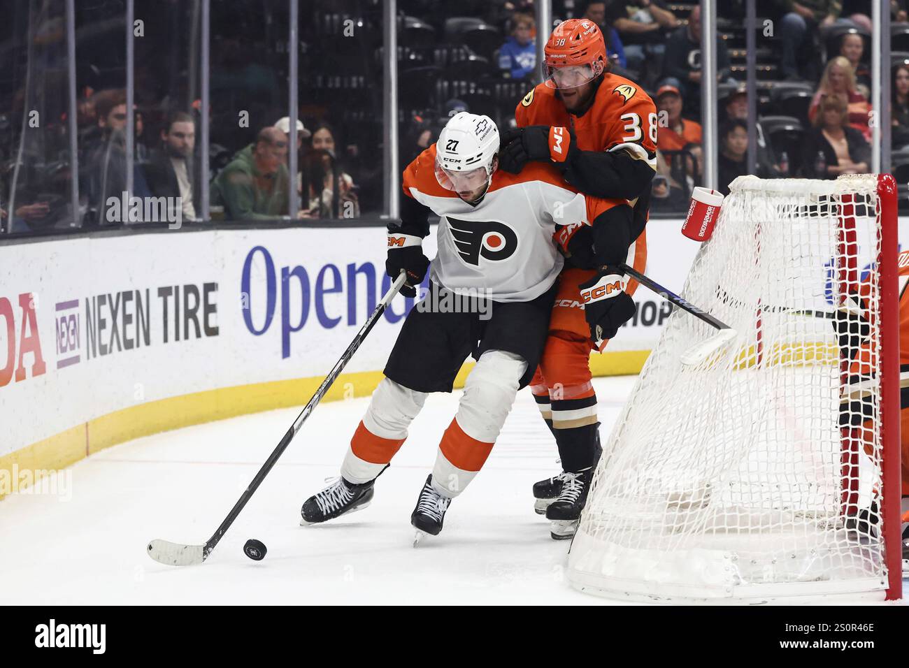 Philadelphia Flyers left wing Noah Cates, left, attempts to recover the ...