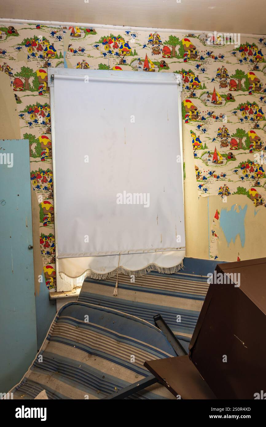 A room with a white wall and a window with a white curtain. The room is ...