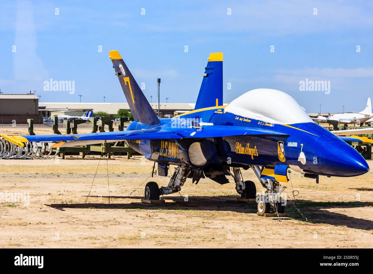 A blue and yellow fighter jet with the number 7 on the tail. The plane ...