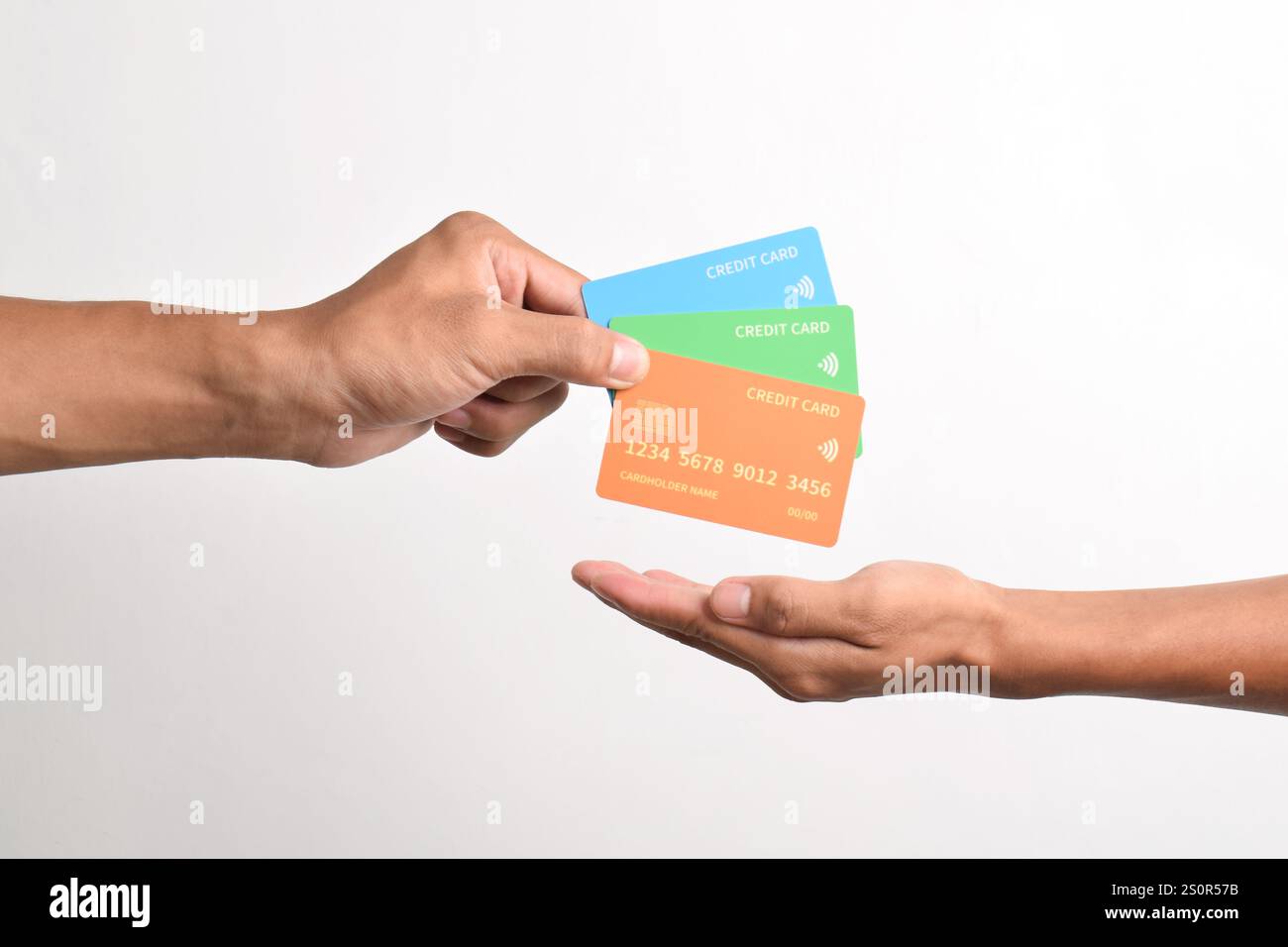 Hand holding three credit cards and other hand receiving isolated on ...