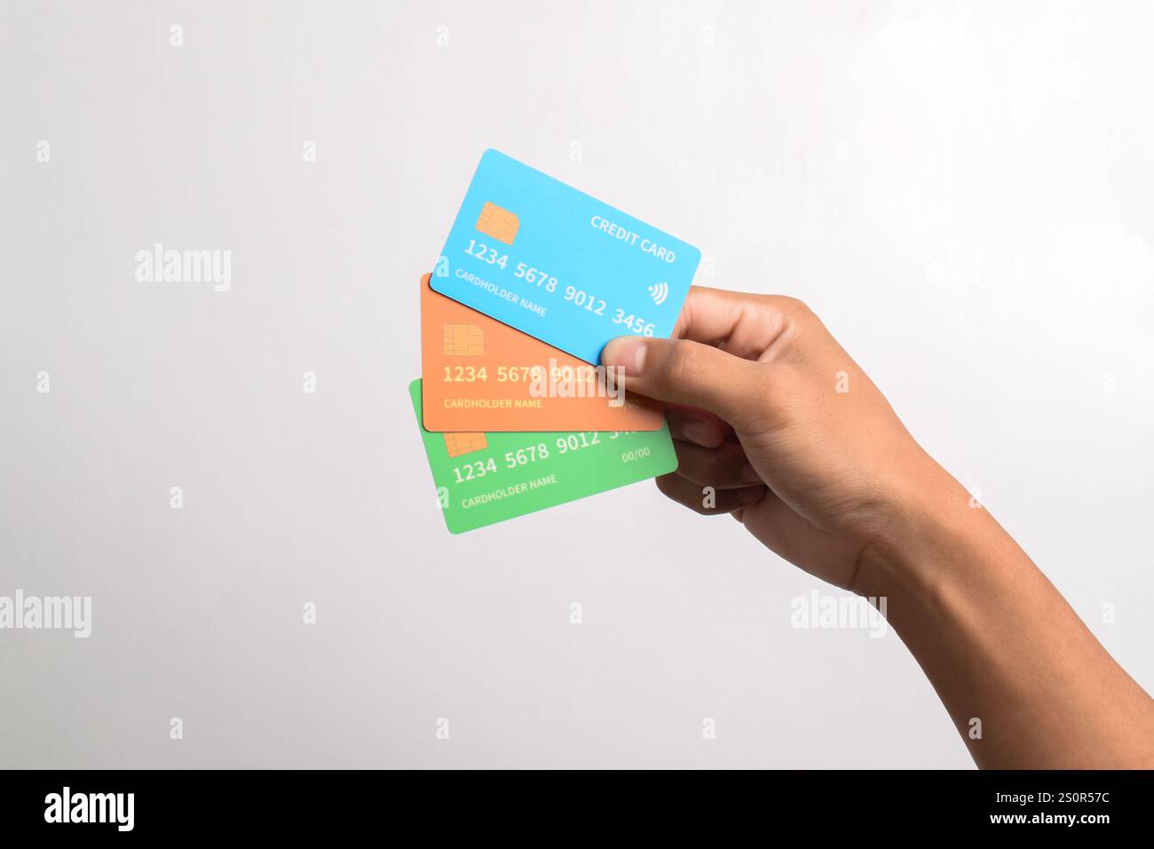 Hand is hold three credit cards. Blue, green and orange credit cards ...
