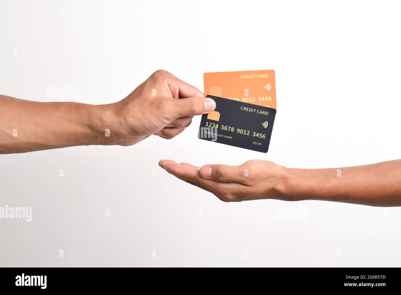 Hand holding two credit cards and other hand receiving isolated on ...