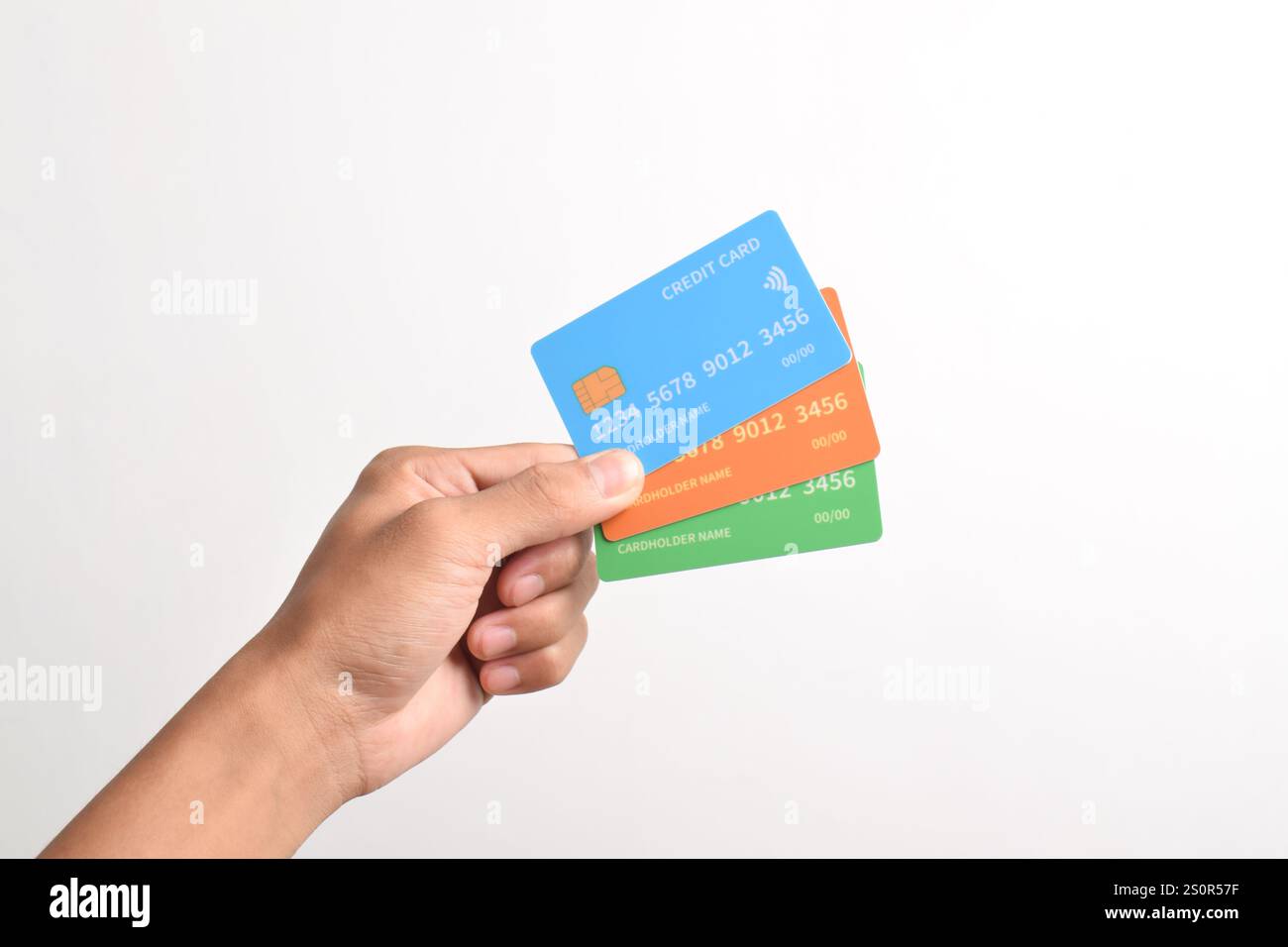 Hand is hold three credit cards. Blue, green and orange credit cards ...